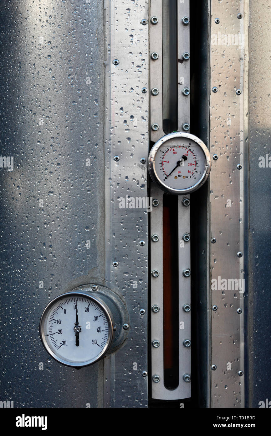Outdoor industrial equipment and pressure gauge meters with raindrops ...