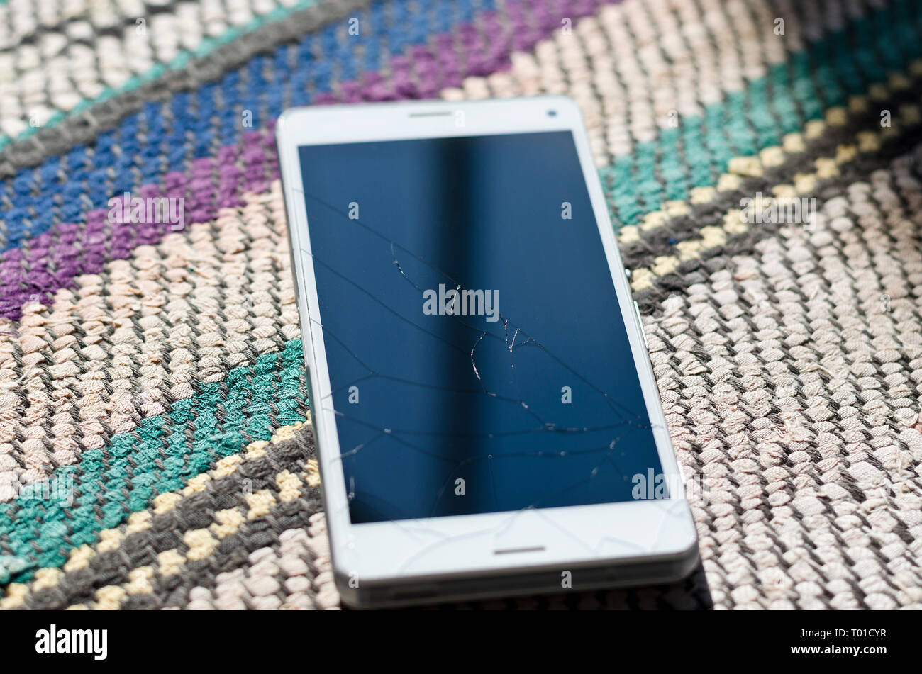 Broken cell phone glass screen on the ground Stock Photo - Alamy