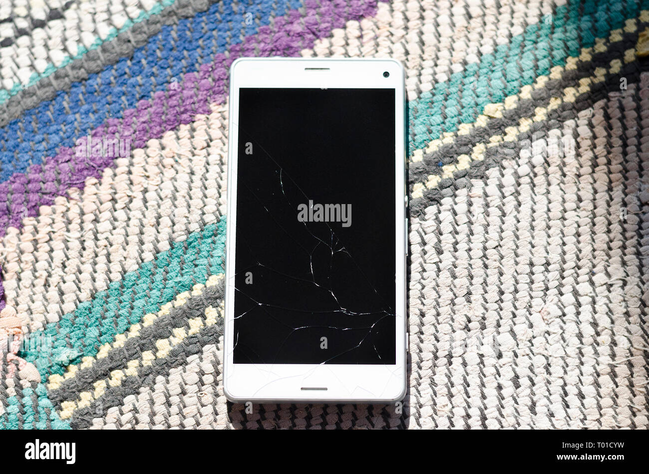 Broken cell phone glass screen on the ground Stock Photo - Alamy