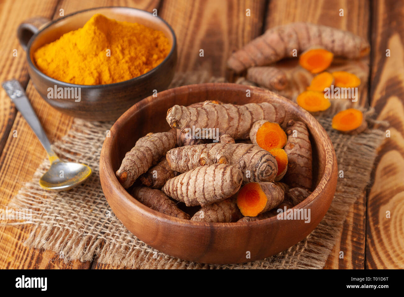 Turmeric roots and powder rustic still life Stock Photo - Alamy