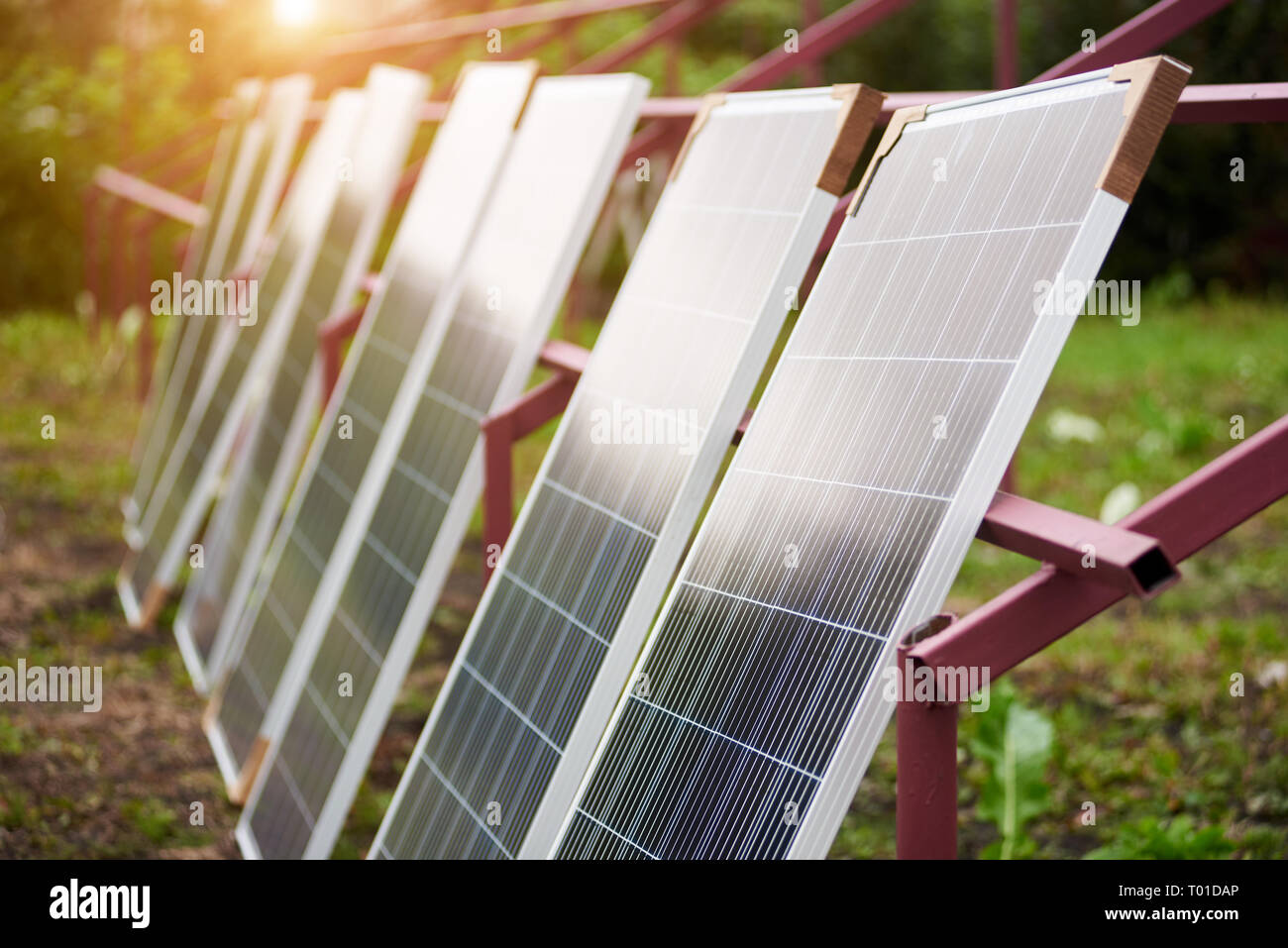 Row of new shiny solar photo voltaic panels arranged outdoors on sunny ...