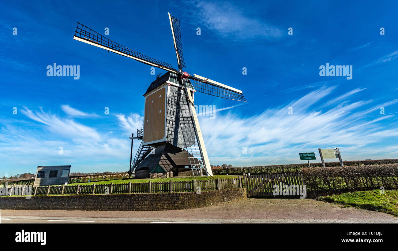 Dutch windmill surrounded by a wood fence on a wonderful sunny day and ...