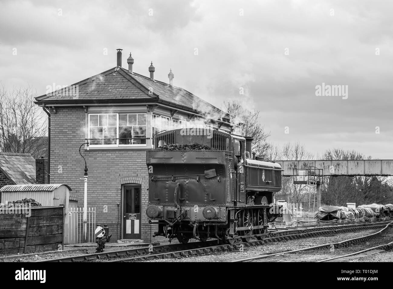 Monochrome rear view of vintage UK steam locomotive in action on Severn ...