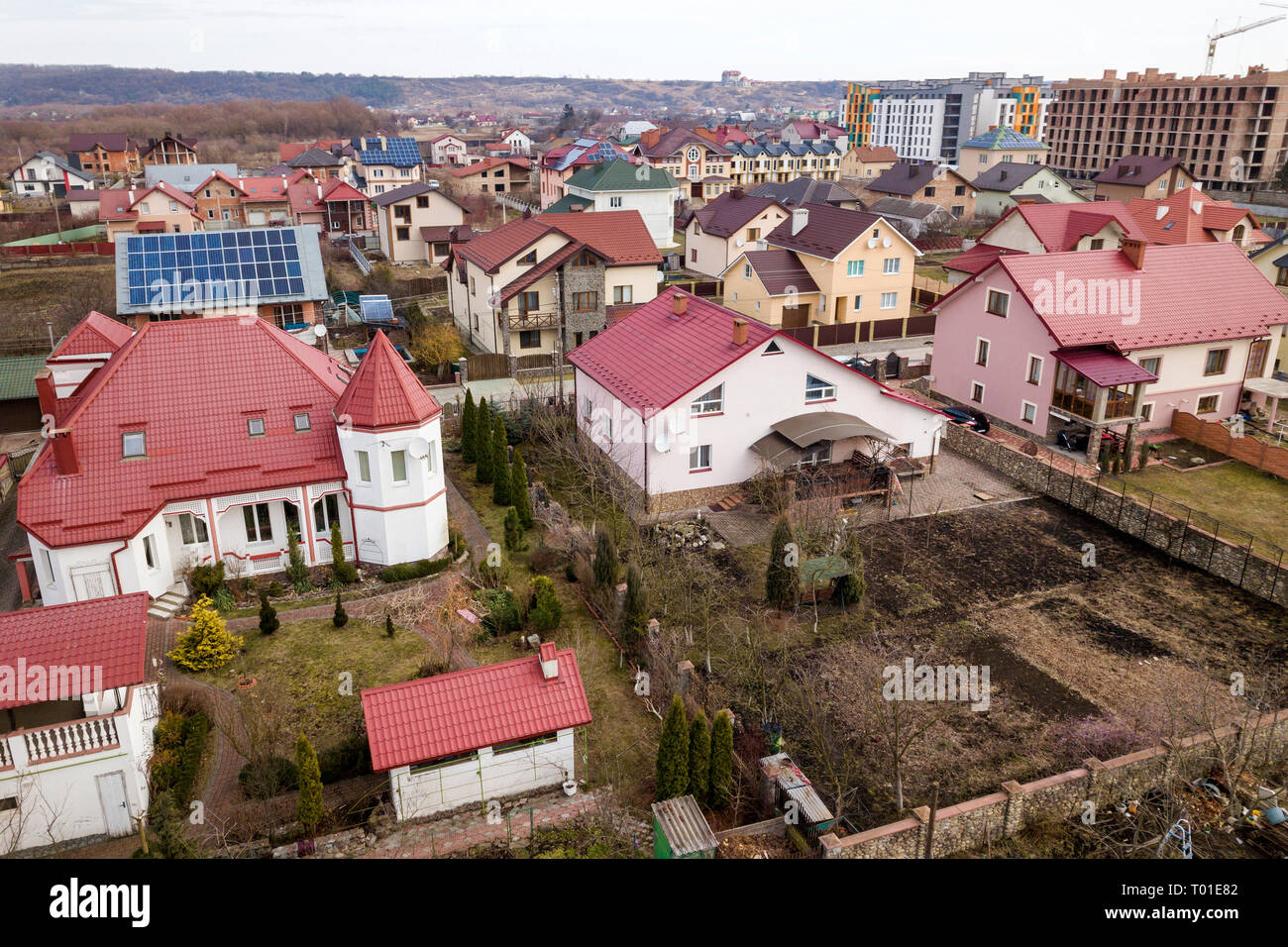 Aerial top view of suburb area with nice houses and cars on sunny day ...