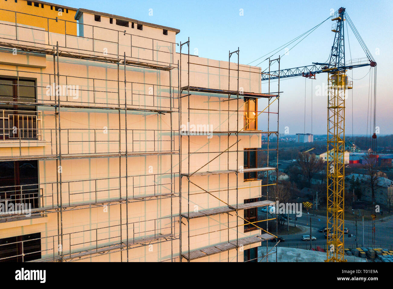 Apartment or office tall unfinished building under construction. Brick ...