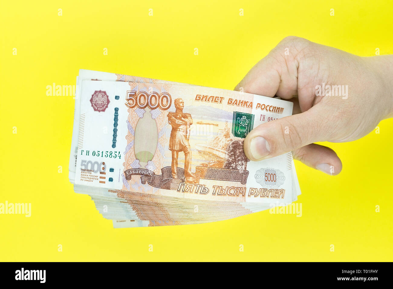 Yellow human hand giving money hi-res stock photography and images - Alamy