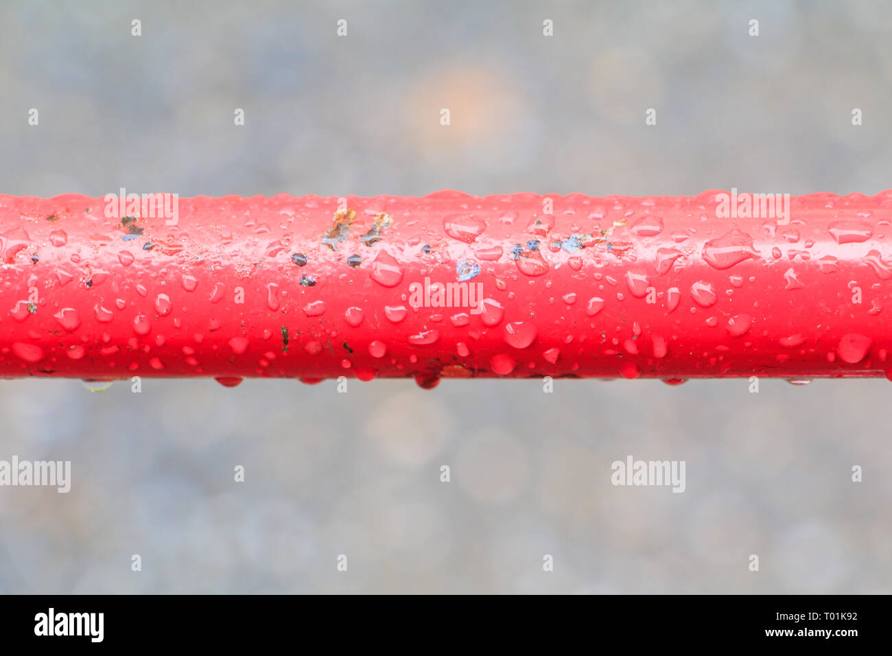 water drops on old metallic steel pipe red background with copy space ...