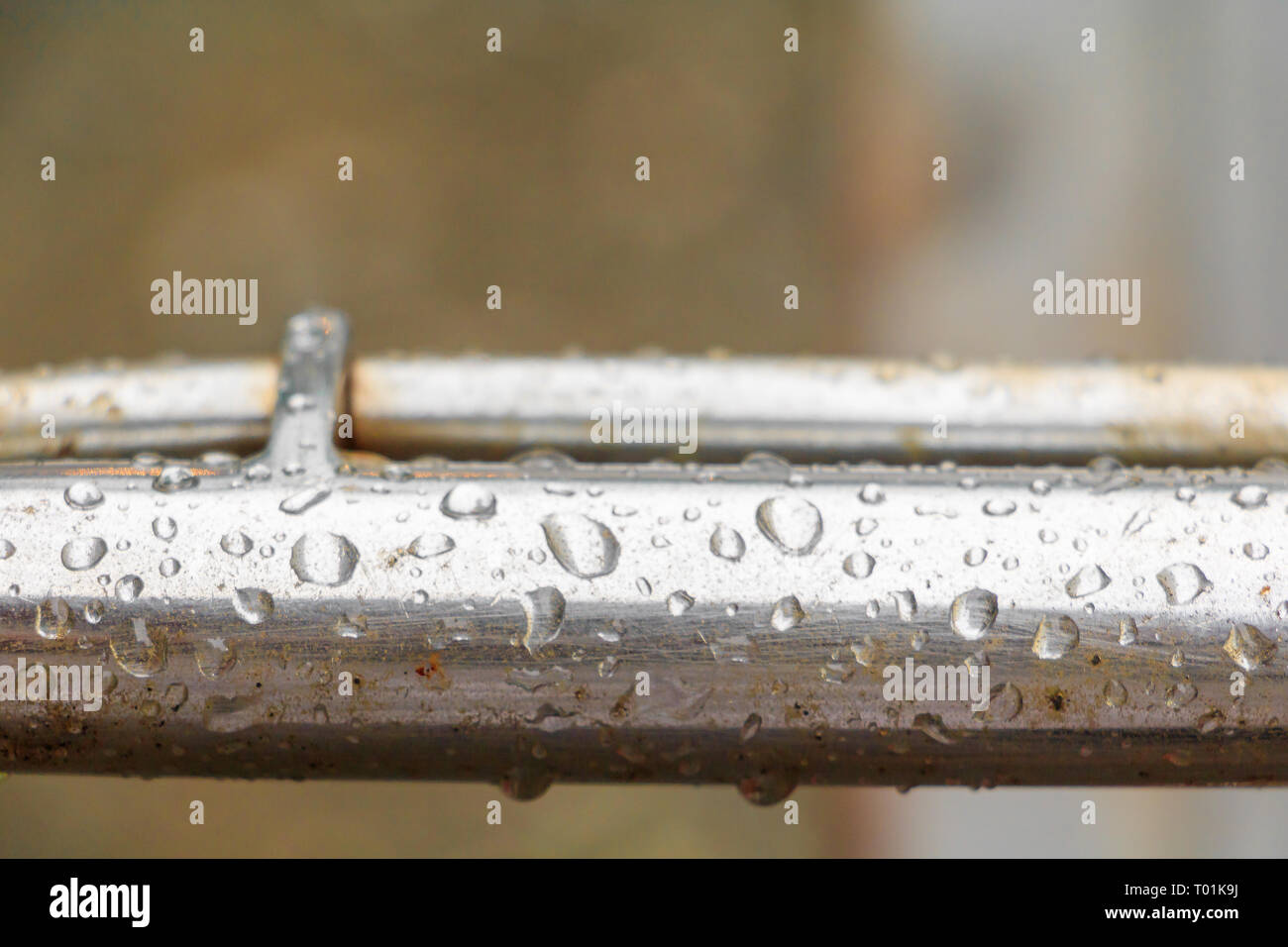 water drops on old metallic steel pipe aluminum background with copy ...