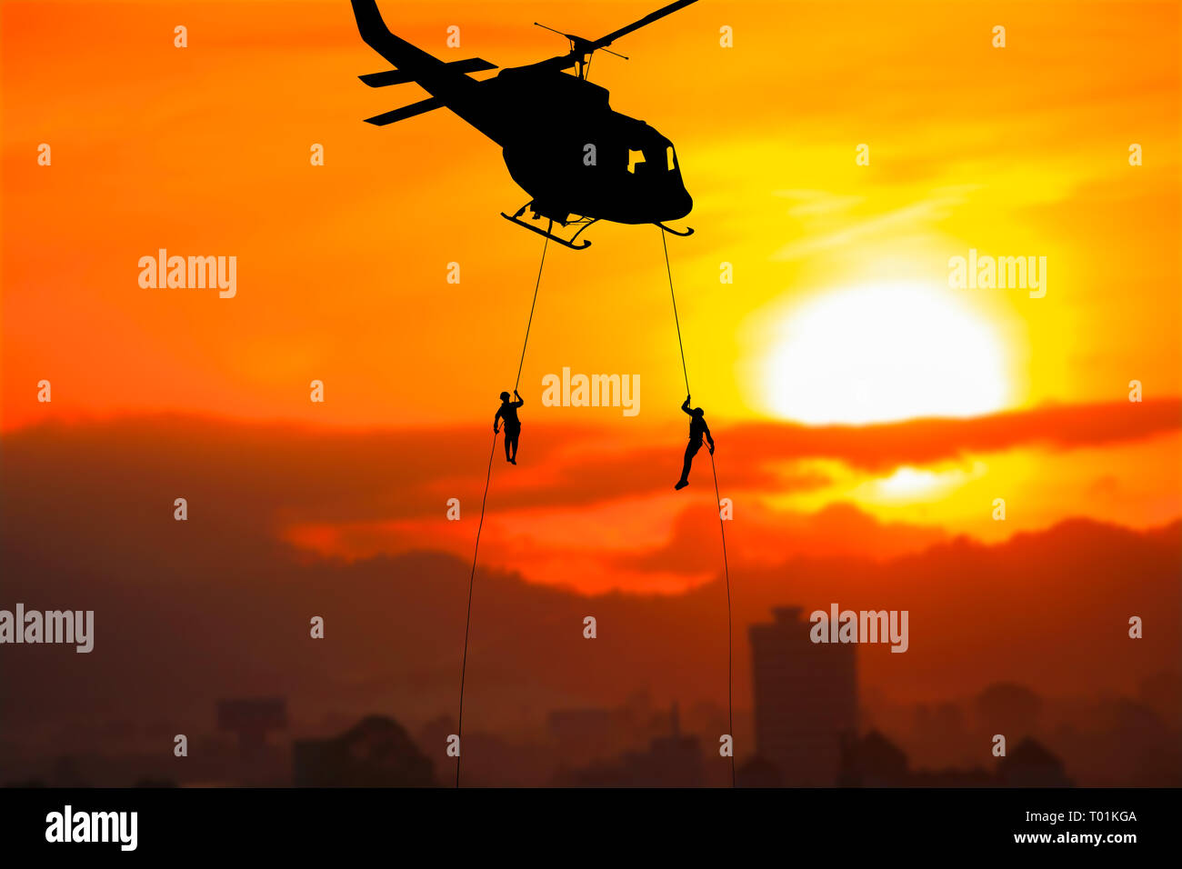 Silhouette Soldiers rappel down to attack from helicopteron with sunset ...