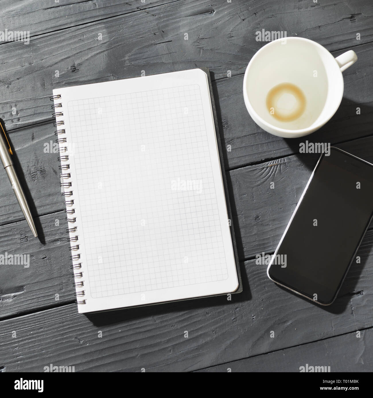 Notepad with blank pages for your text on a dark wooden table top view ...