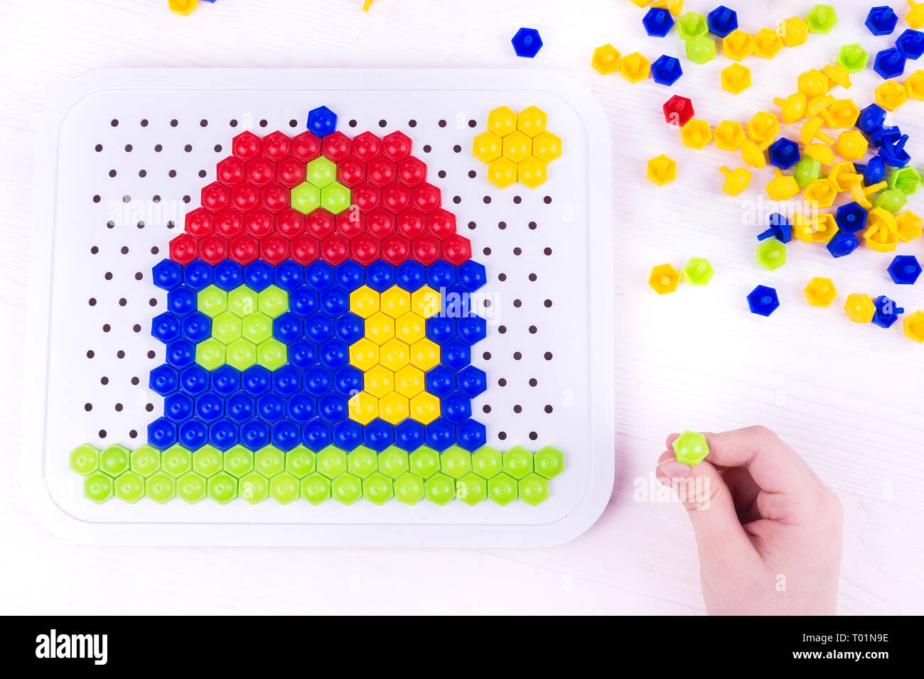 child building a mosaic house on a white background Stock Photo - Alamy