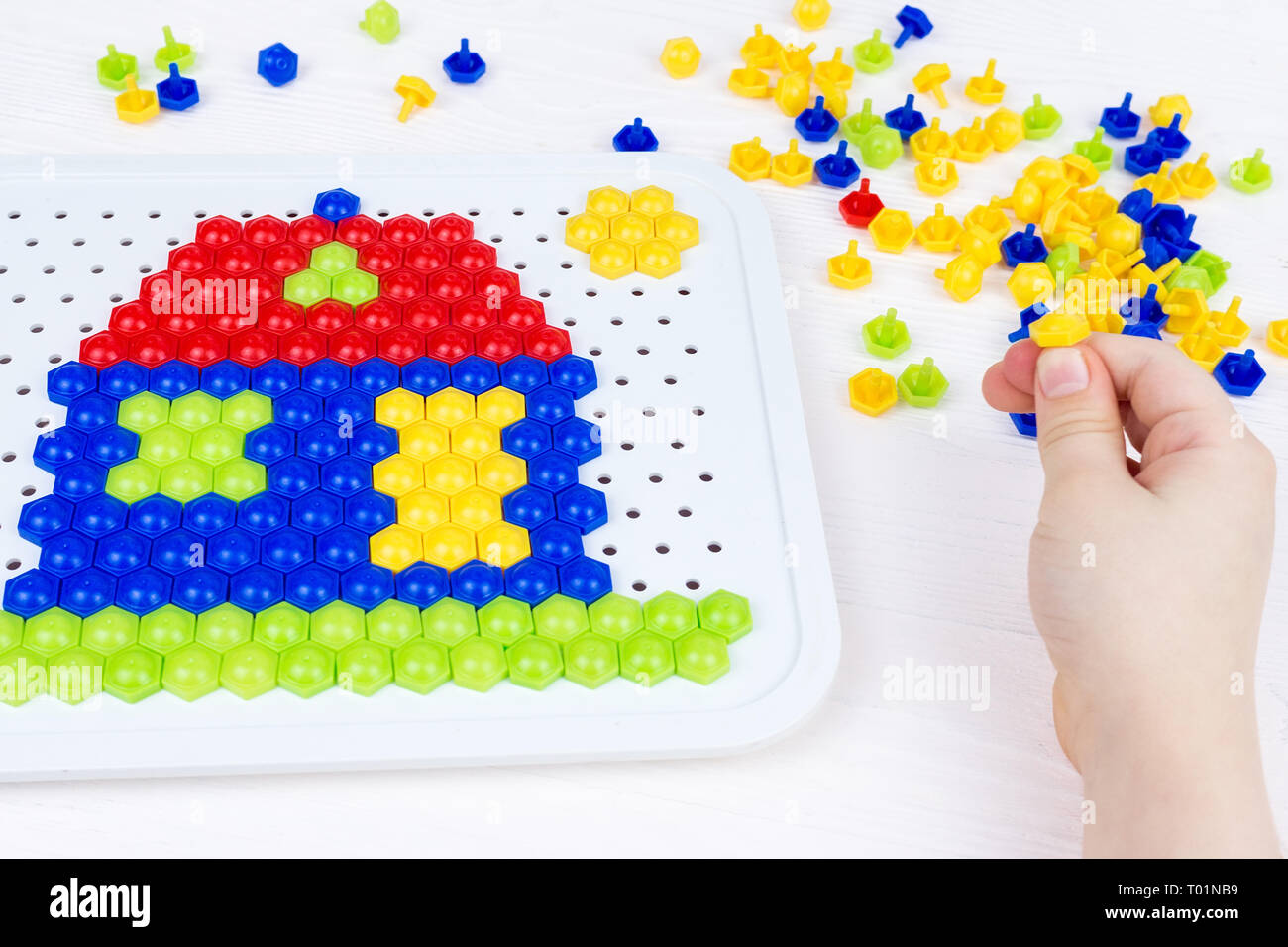 child building a mosaic house on a white background Stock Photo - Alamy