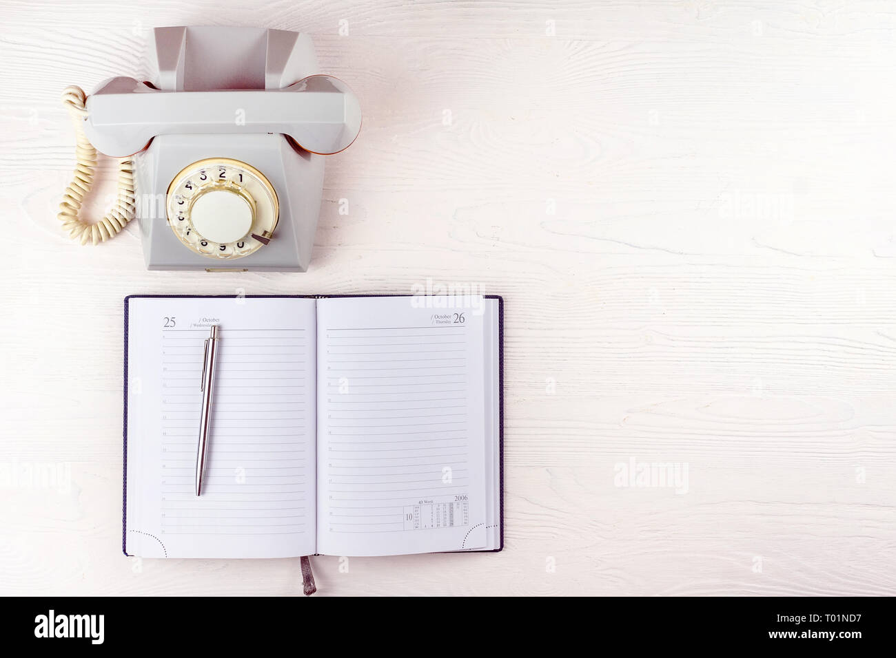 old phone with a notebook on a white background Stock Photo - Alamy