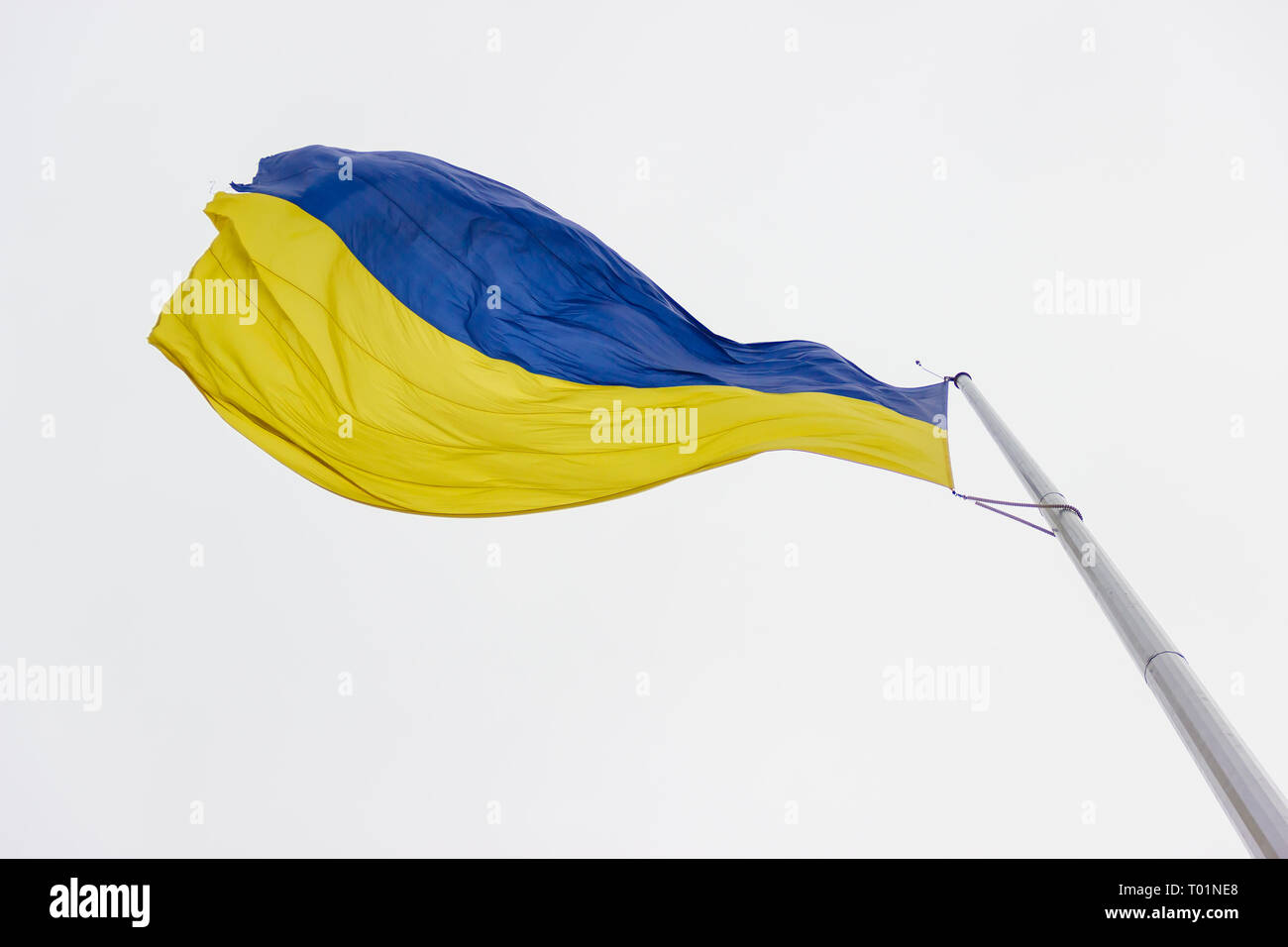 The flag of Ukraine flutters in the wind on a high flagpole in Dnipro ...