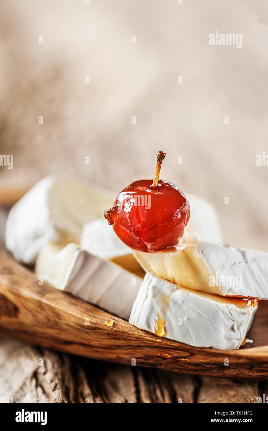 Baked camembert with honey on a beautiful old wooden background Stock ...