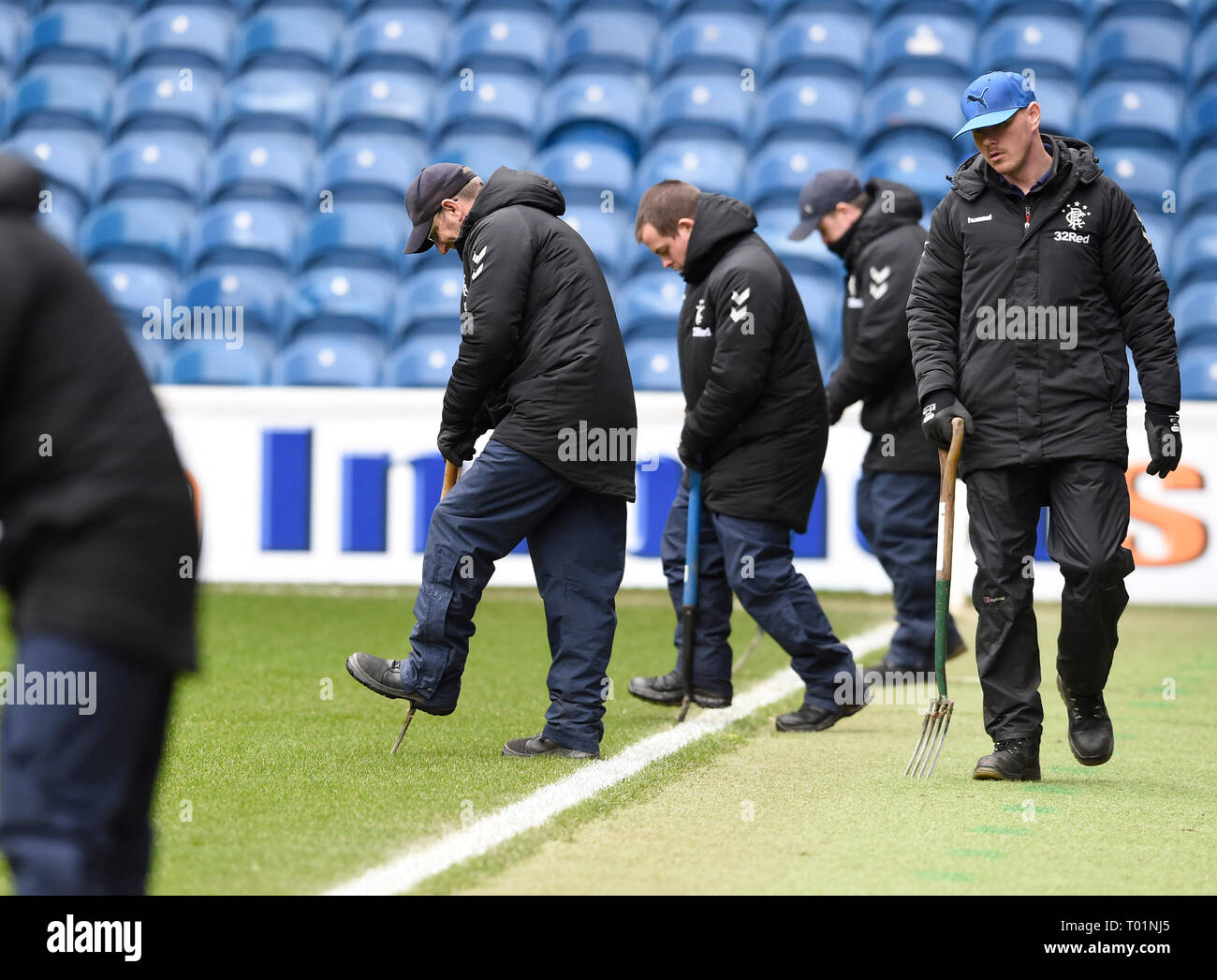 Ibrox ground staff fork the pitch before the Ladbrokes Scottish ...