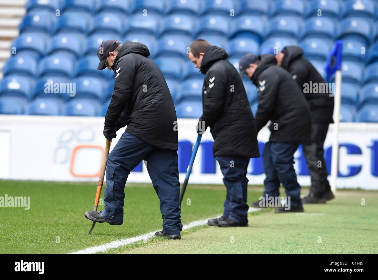 Ibrox ground staff fork the pitch before the Ladbrokes Scottish ...