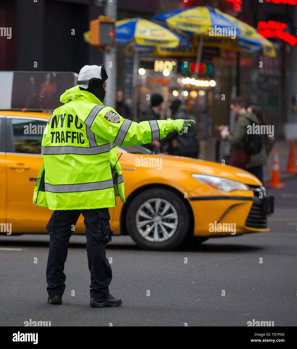 A NYPD Traffic cop directs cars in Times Square, New York City, NY, USA ...