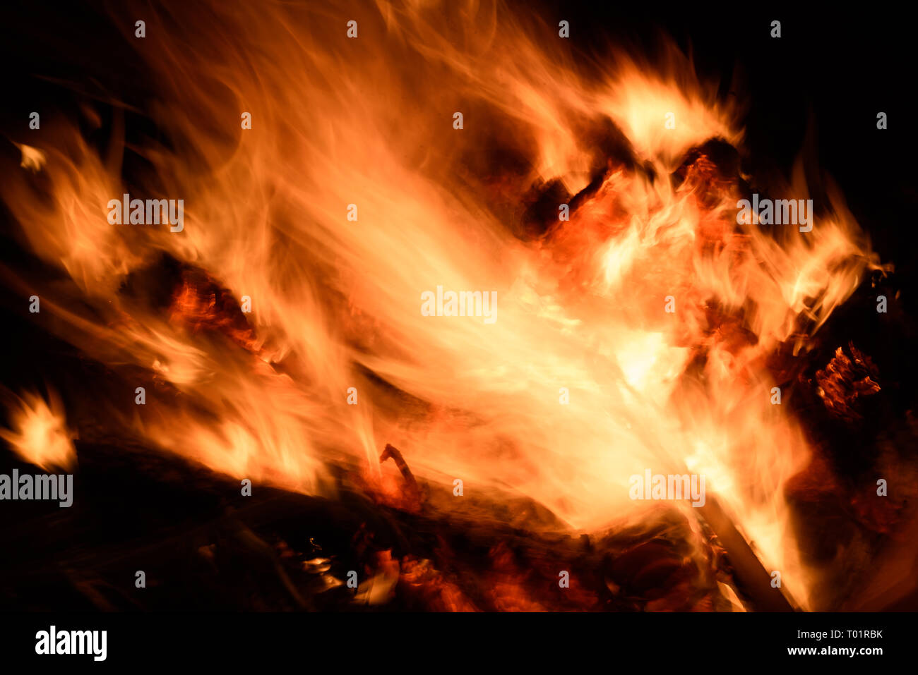 Burning raging fire at night with intentional movement of the flames ...