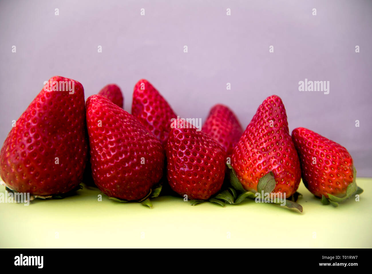 strawberries range on pastel color background Stock Photo - Alamy