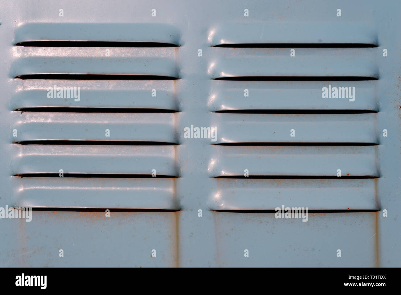 Closeup macro image of a green ventilation air intake grill on green ...