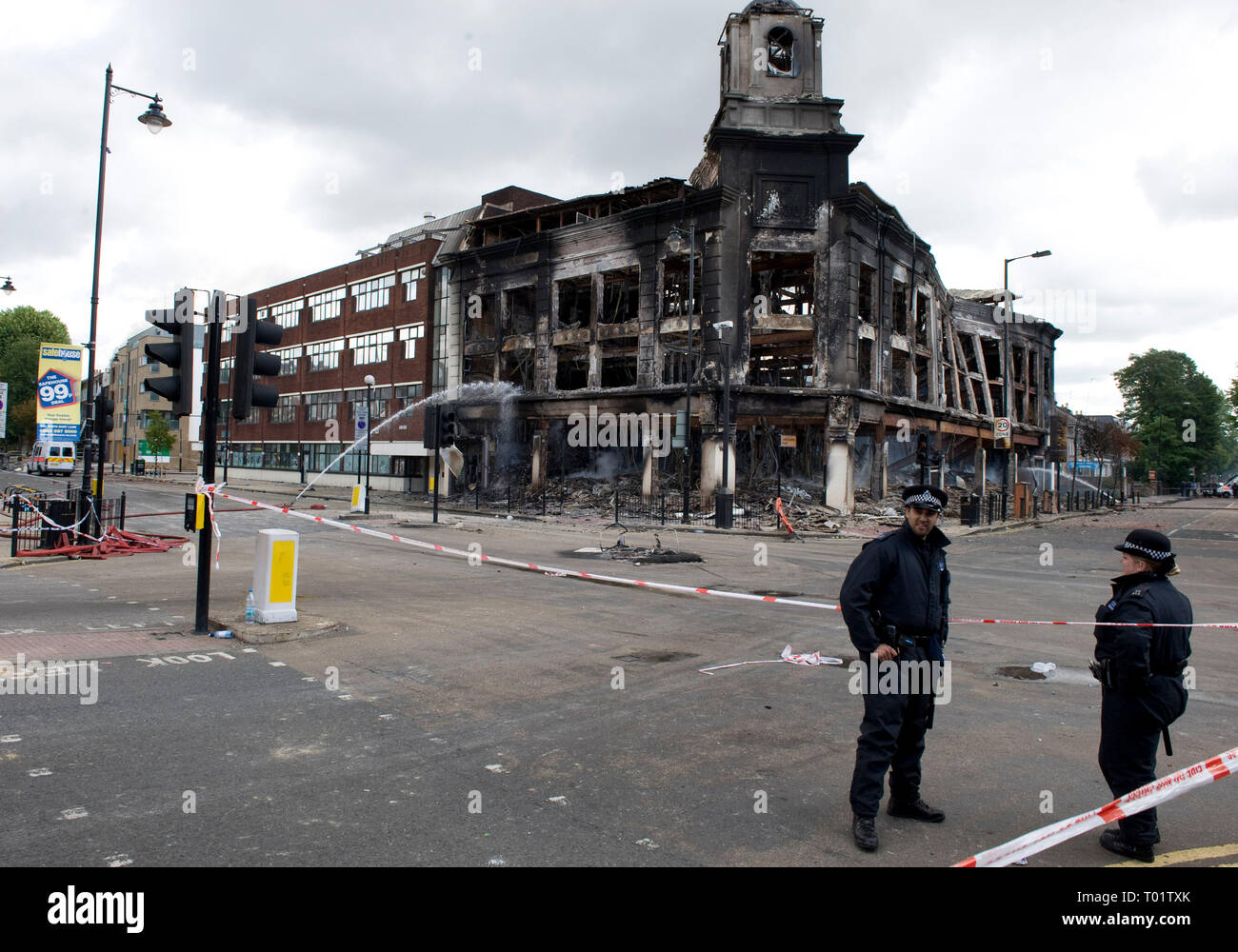 Aftermath of the Tottenham riots . Local residents survey the damage ...