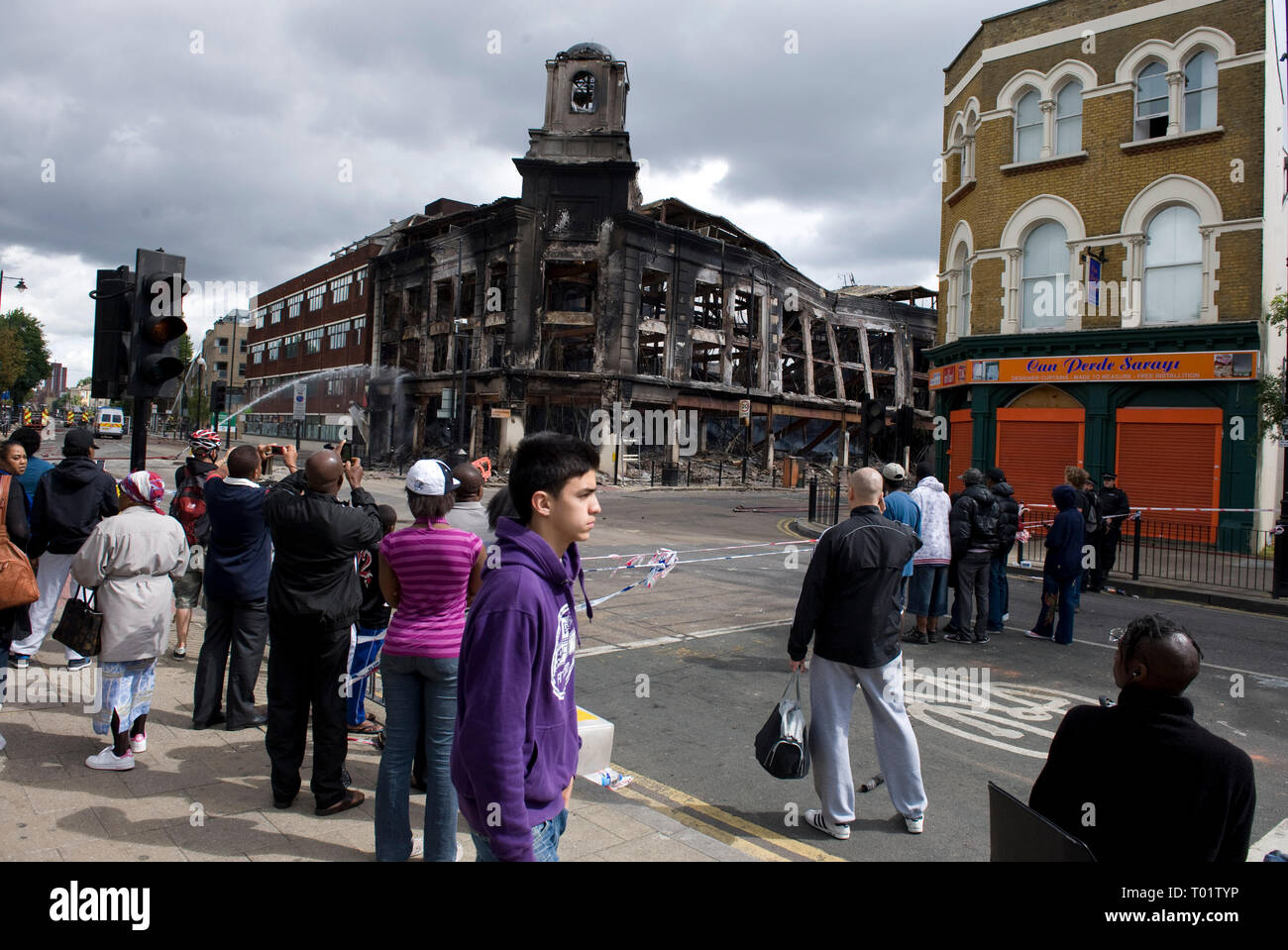 Aftermath of the Tottenham riots . Local residents survey the damage ...