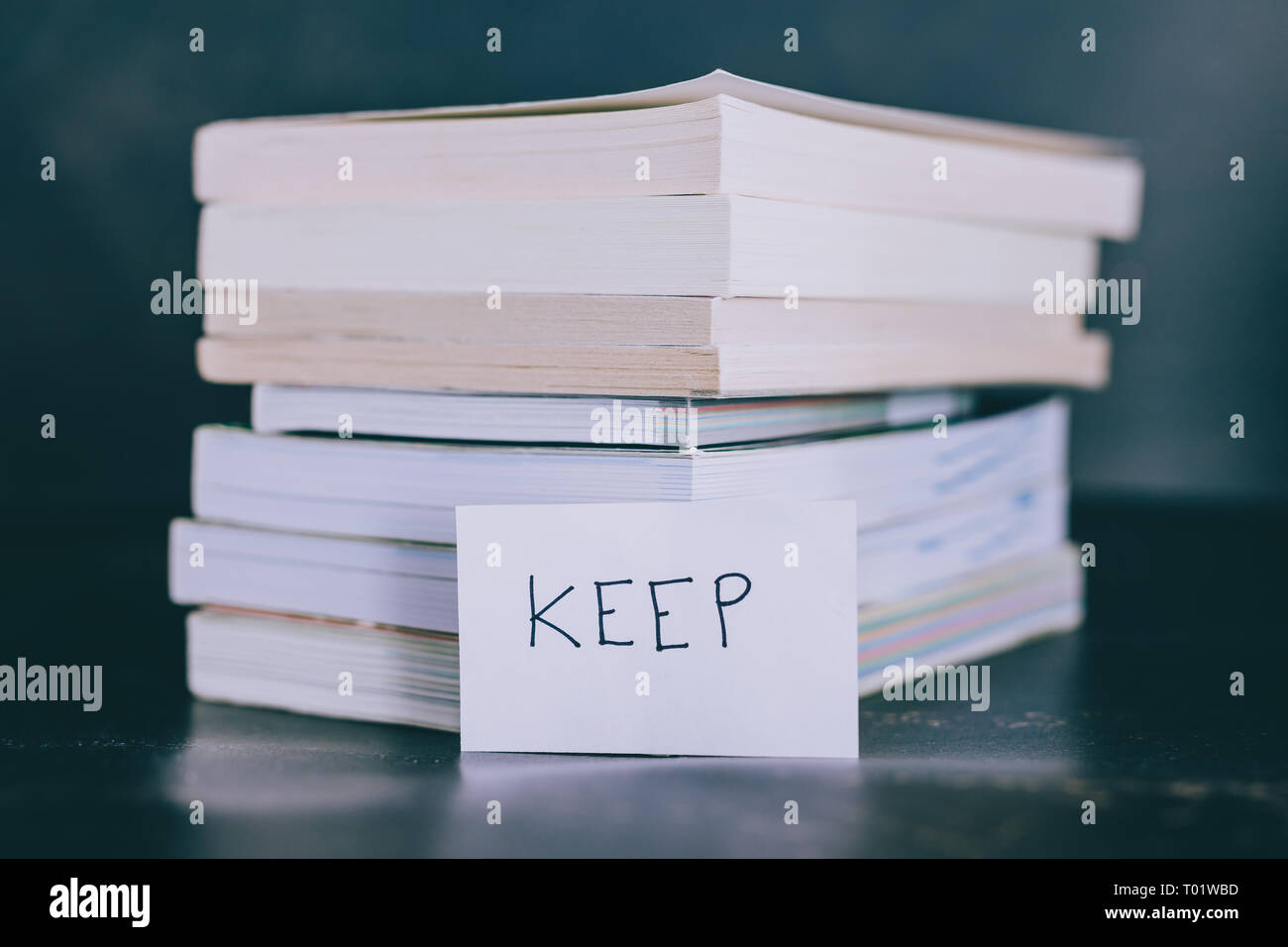 decluttering and tidying up concept: selecting which books to keep and ...