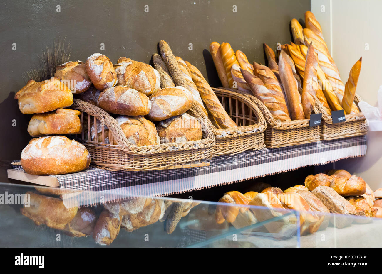 Assorted fresh bread on counter in European bakery Stock Photo - Alamy