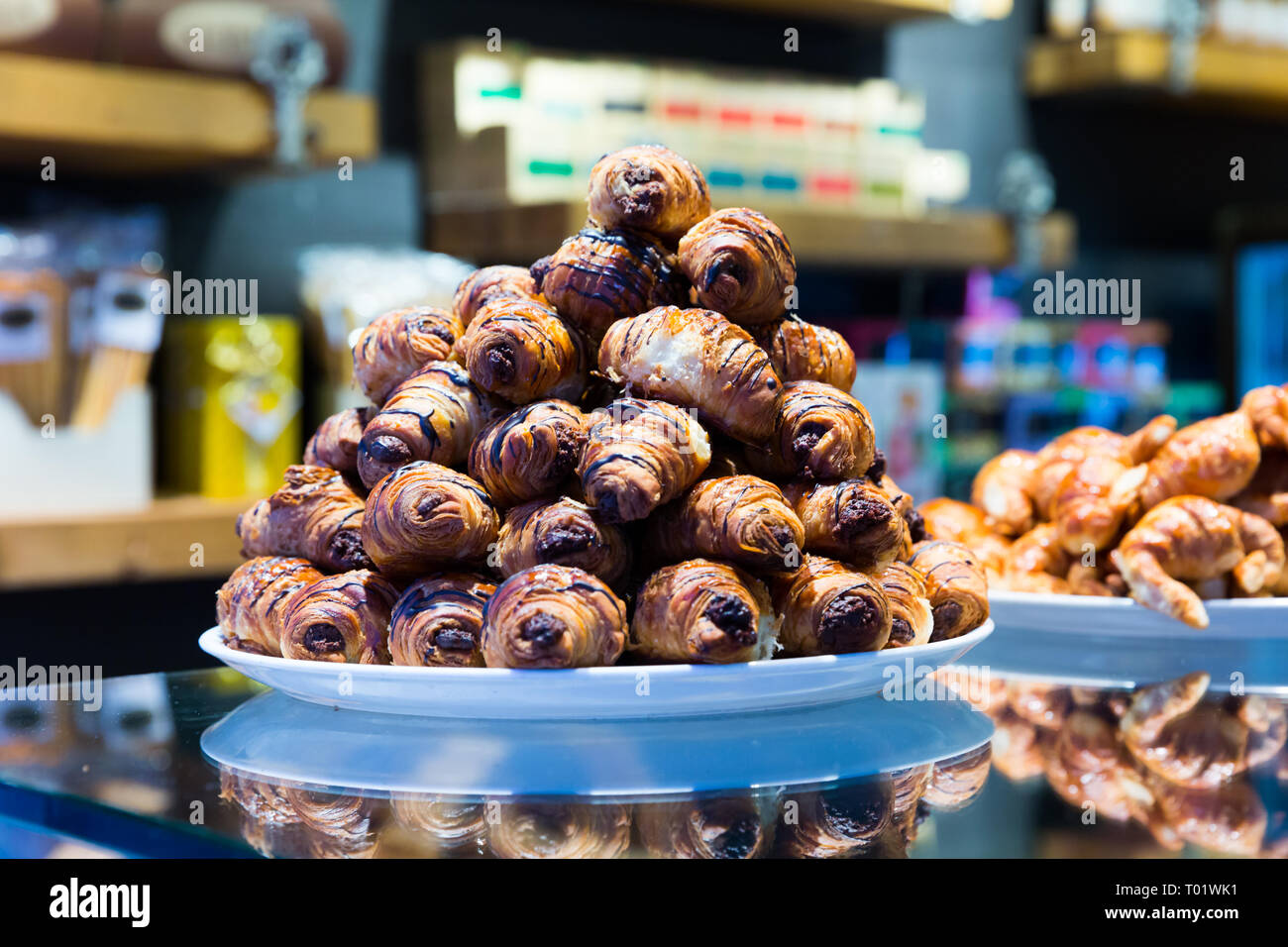 View of glass display with various croissants in pastry shop in Europe ...