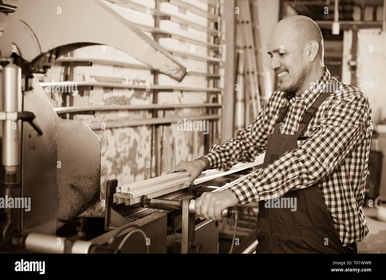 Portrait of middle age workman at professional lathe in plant Stock ...