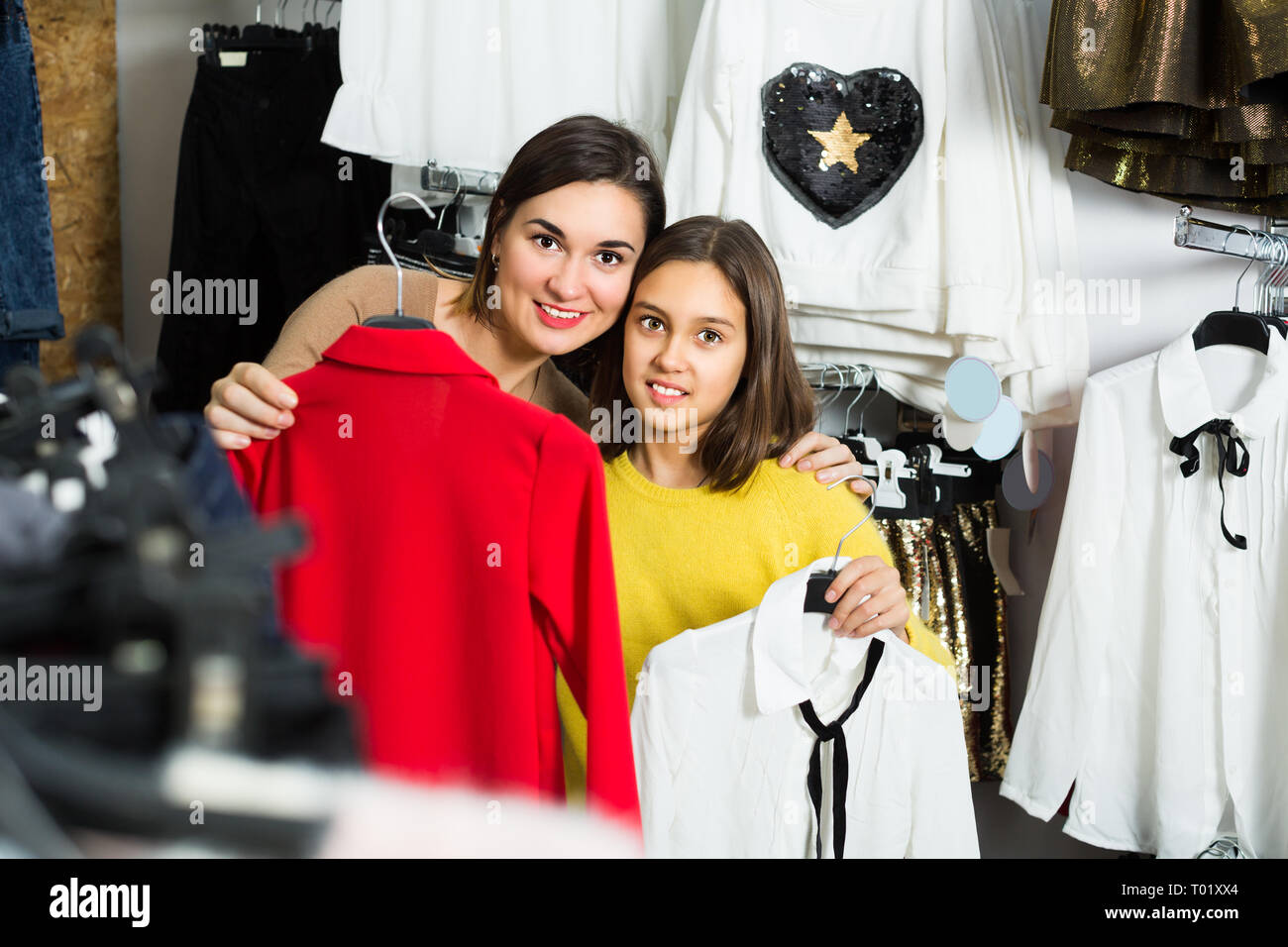 Mother and daughter are boasting by their purchases in children’s ...