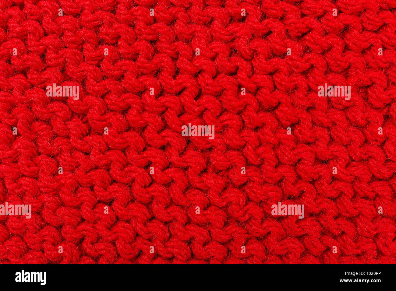 the texture of the crochet, red background, patterned knitted fabric ...