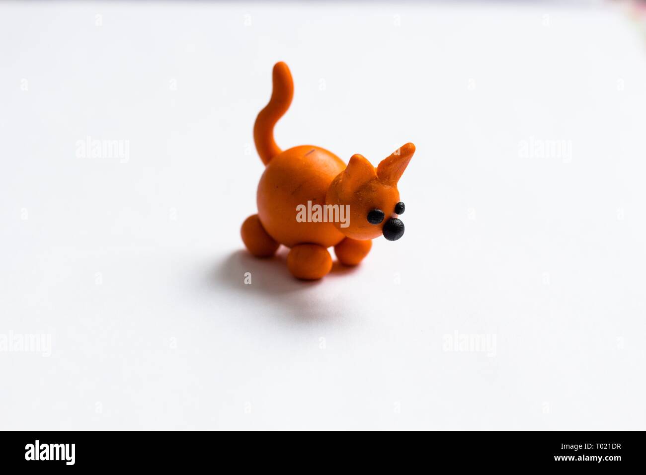 One small dog of orange color on a light background is made of ...
