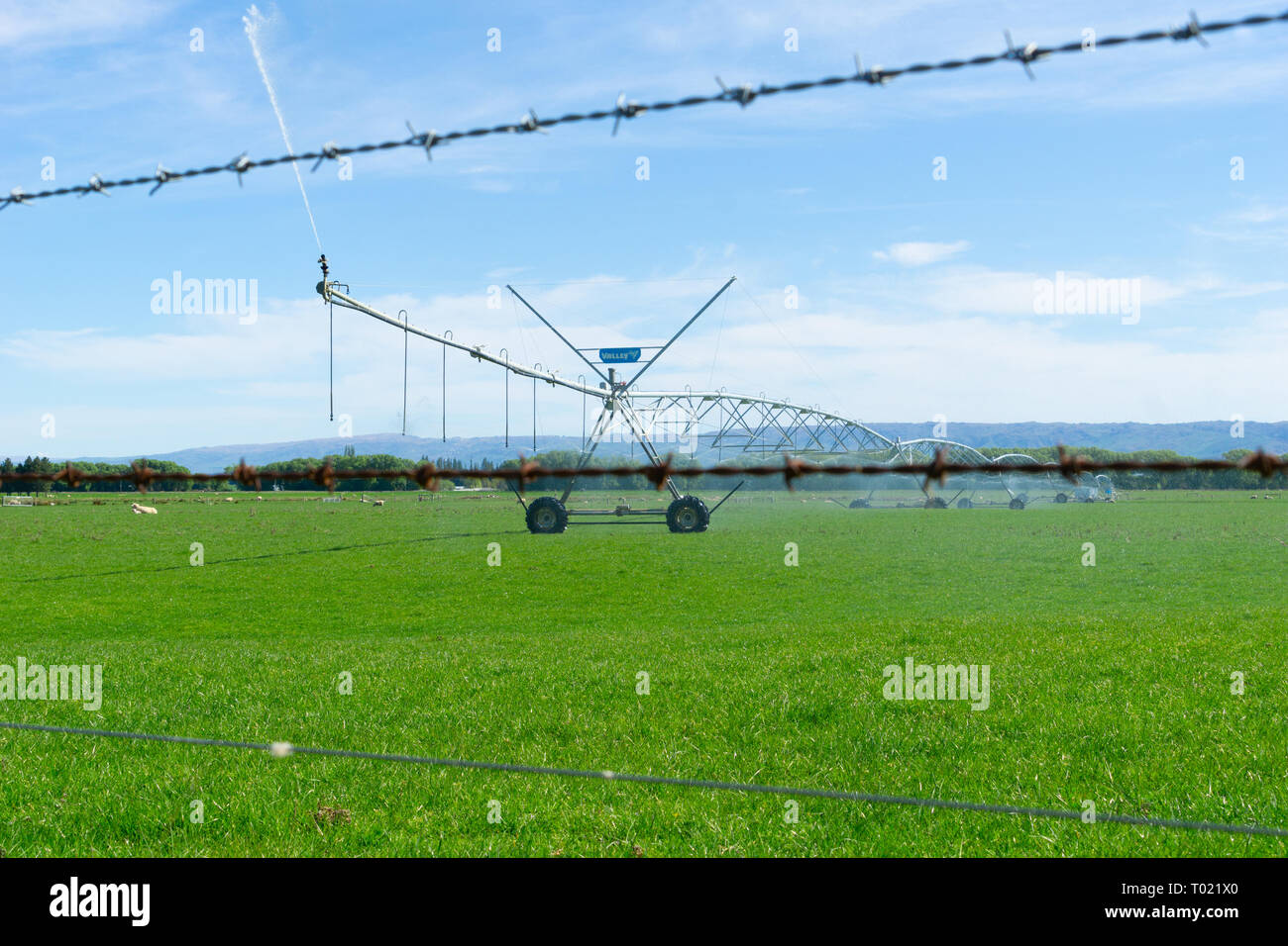 On other side of barbed wire fence a large centre pivot irrigation ...