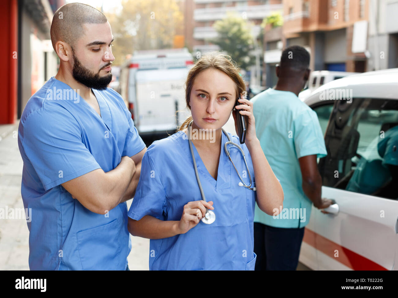 professional ambulance team going to call with medical equipment ...
