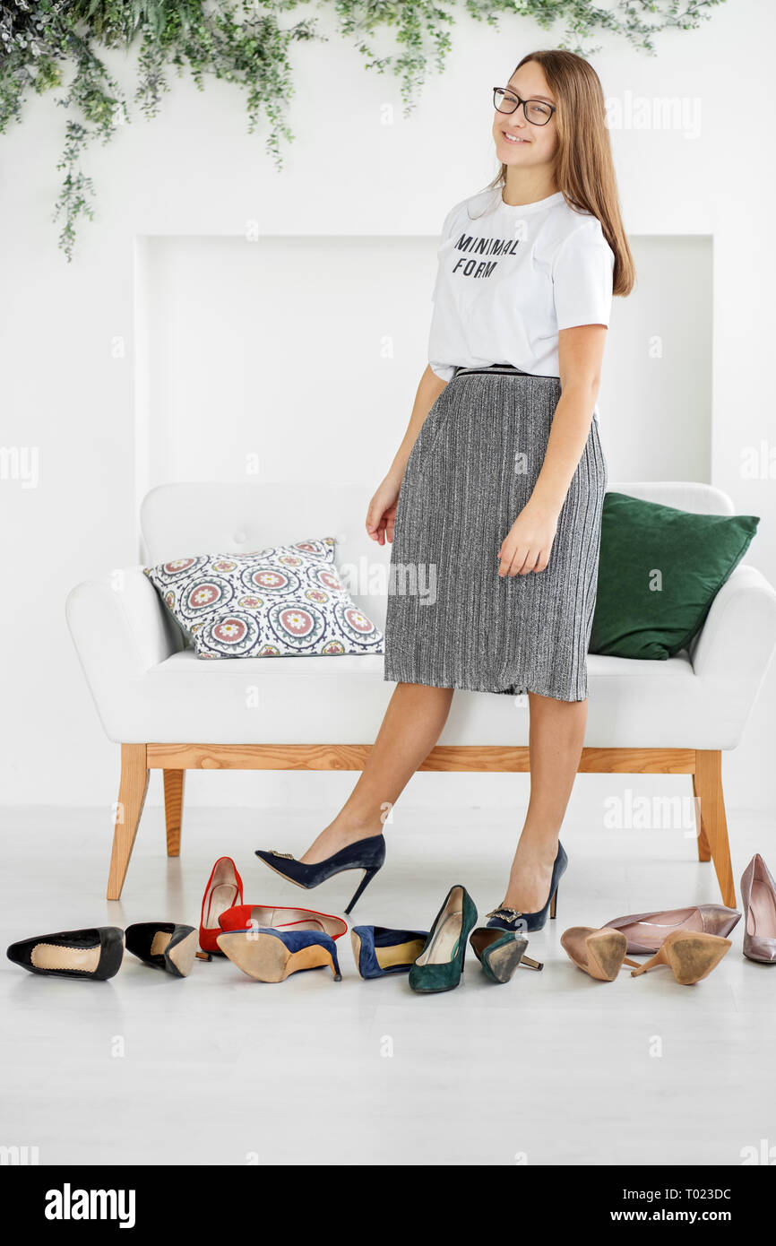 Young stylish girl and a lot of shoes with heels. Concept fashion ...