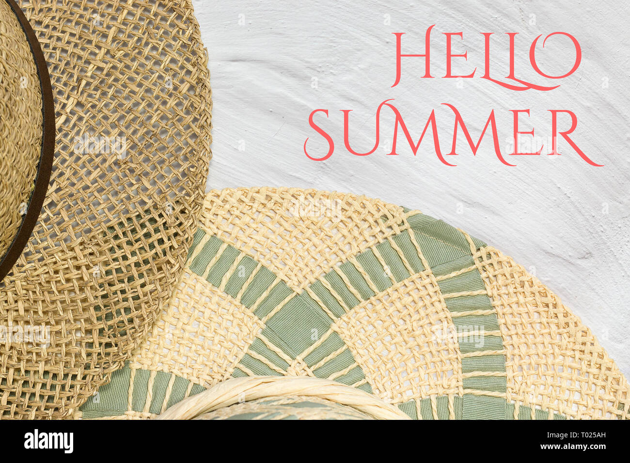 Straw hats, Hello summer text on white limed background, copy space ...
