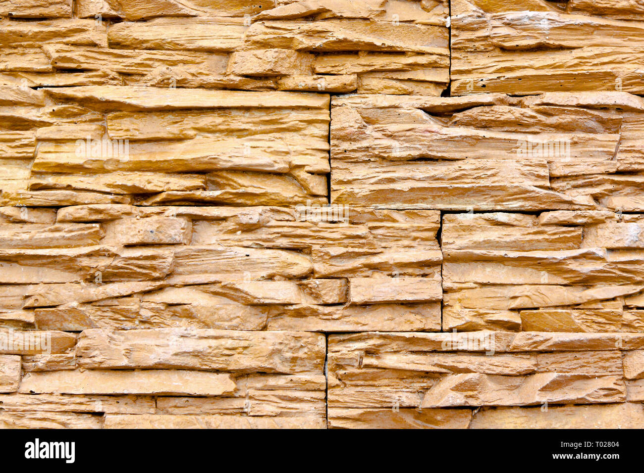Background image of wall made of natural stone tiles Stock Photo - Alamy