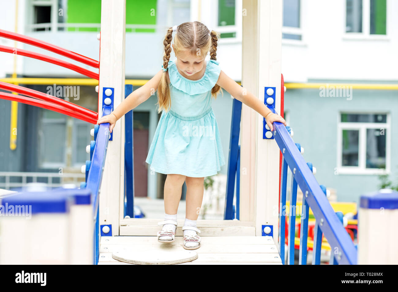 A small child is playing on the playground. The concept of childhood ...