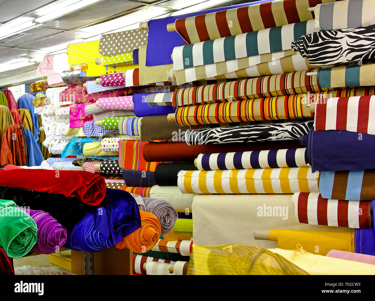 Colorful textile fabric material rolls for fashion Stock Photo - Alamy
