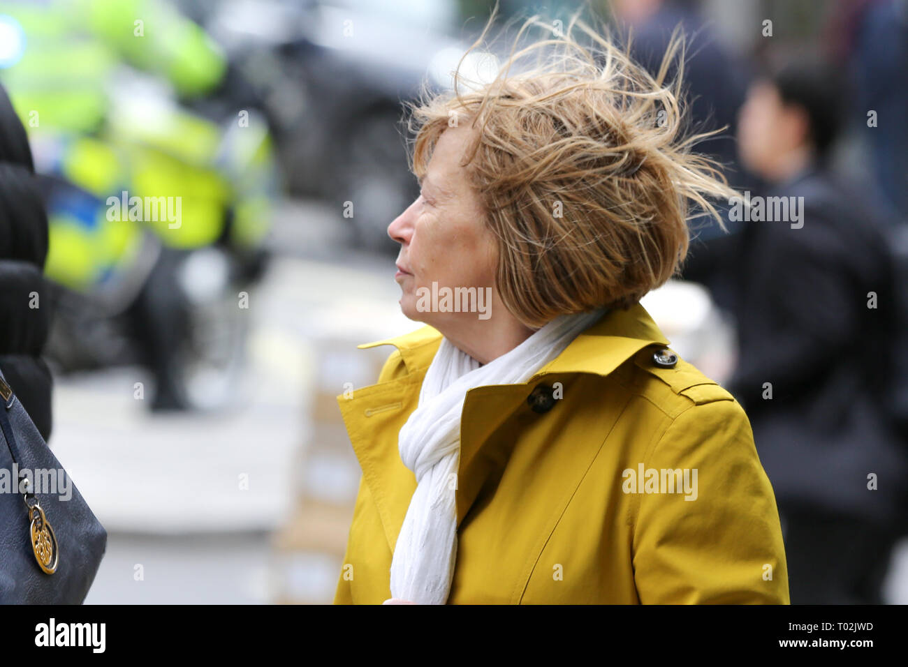 London, UK. 16th March 2019. Woman's hair blowing during strong wind in ...