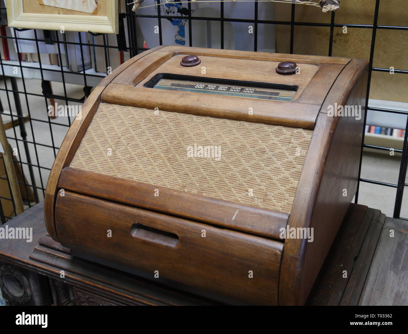 Old radio in a wooden box with two knobs and a shelf for records Stock ...