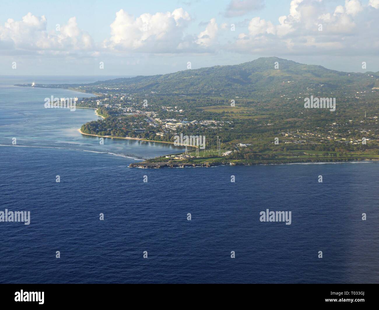 Aerial view of Saipan western coast from a distance, with the deep blue ...