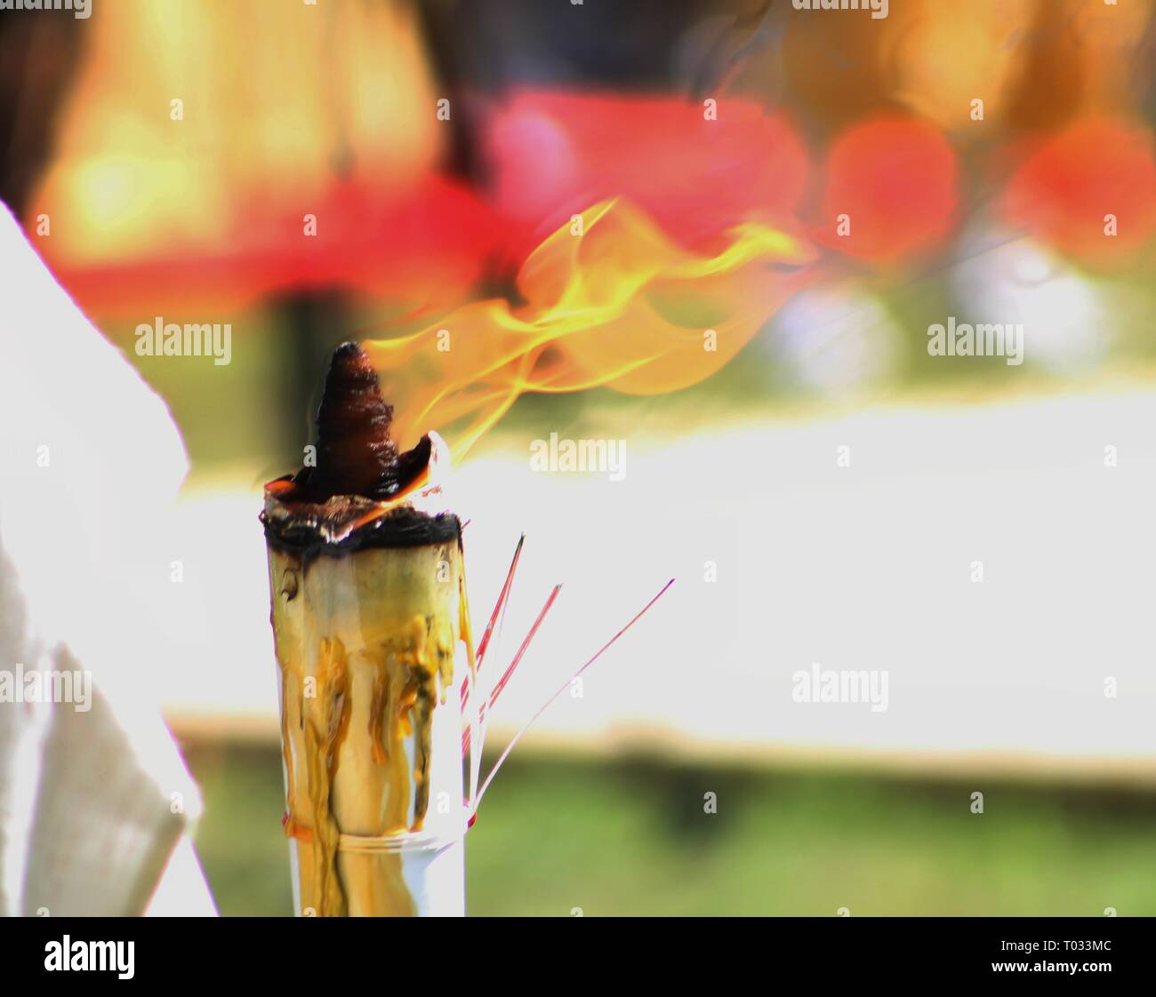 Flaming tiki torch in a blurry background Stock Photo - Alamy