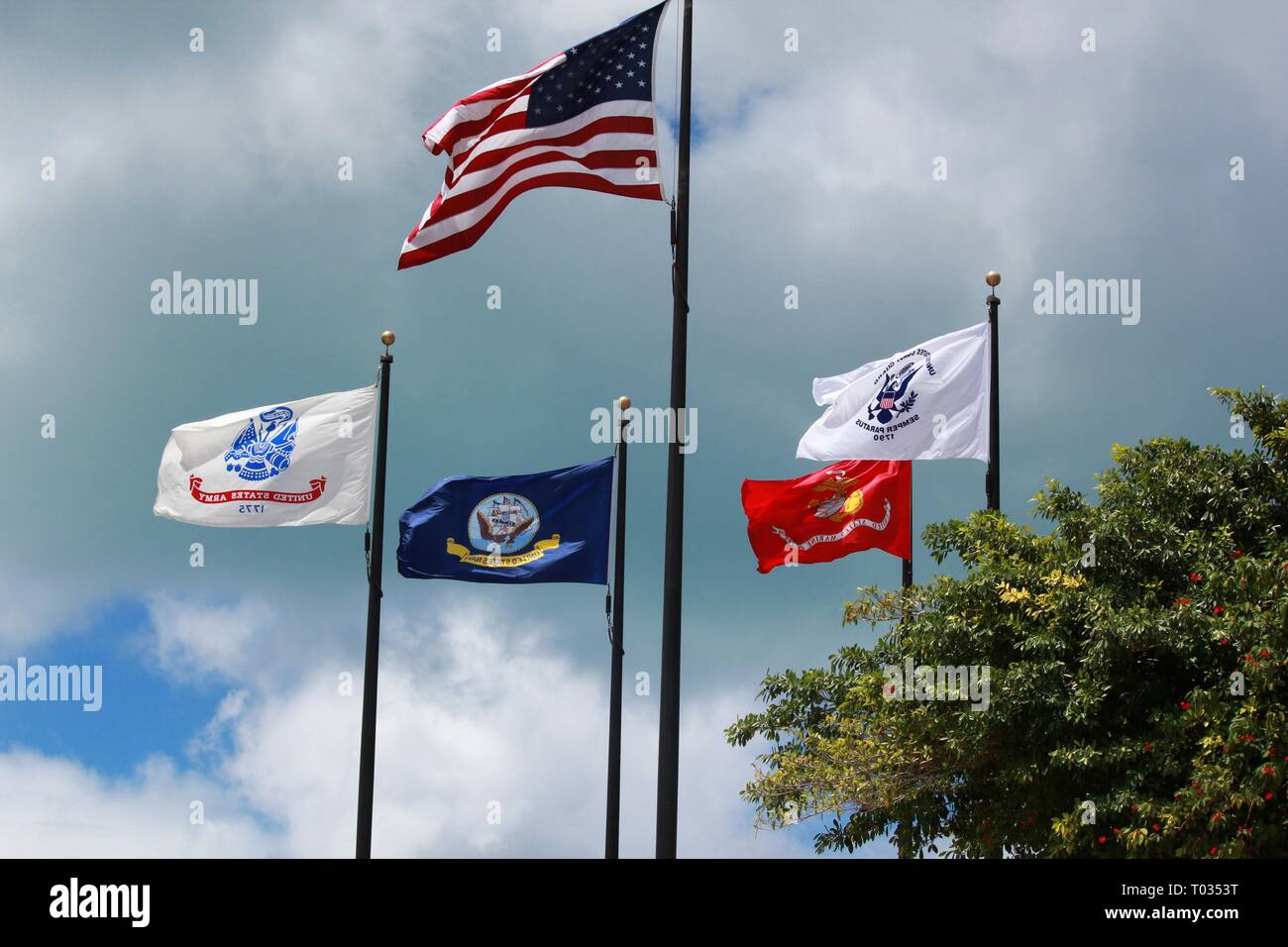 The United States flag flanked by the flags of the, US Coast Guard, US ...