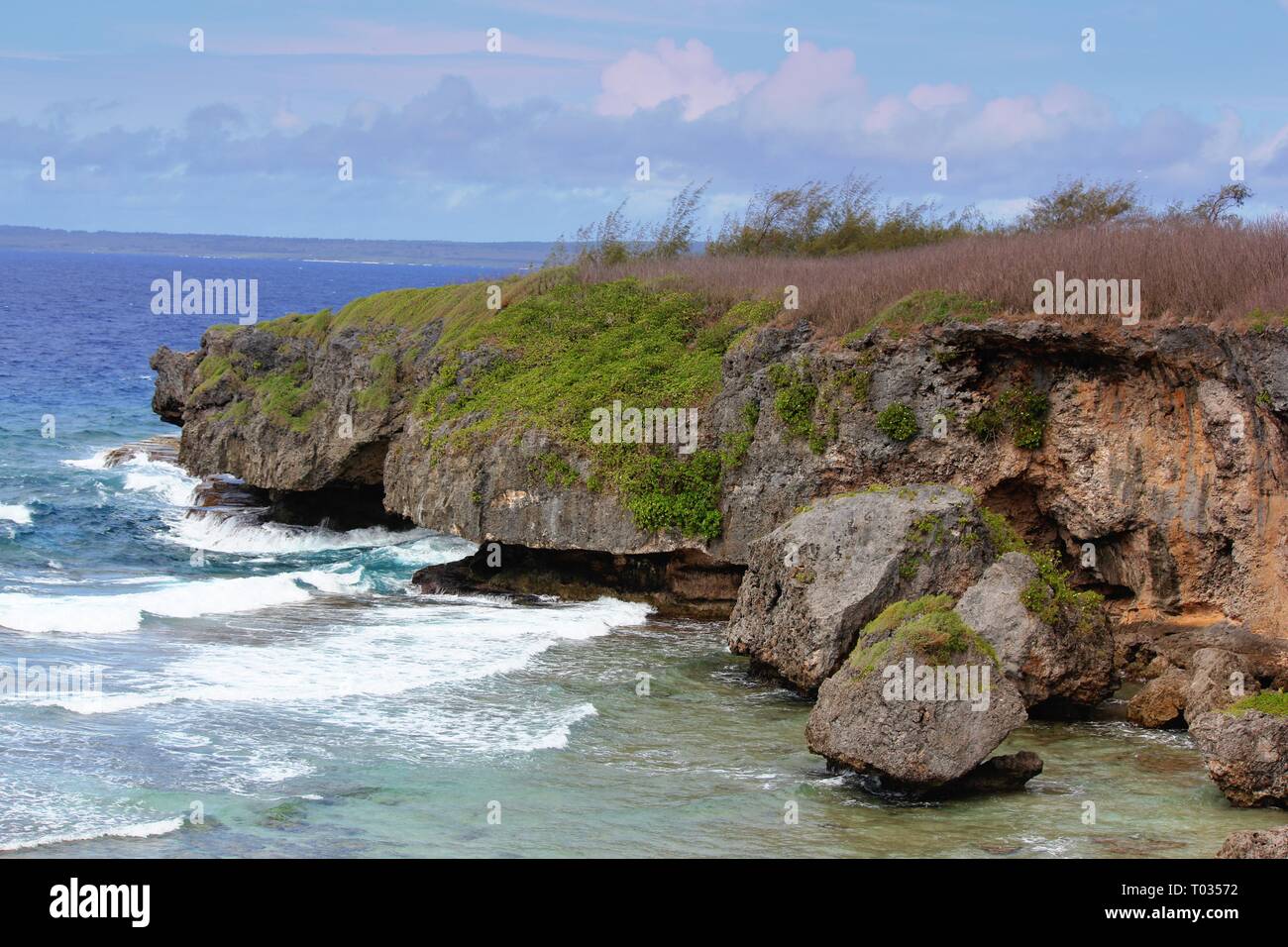 Beautiful rock formations and cliffs border a coastal beach Stock Photo ...