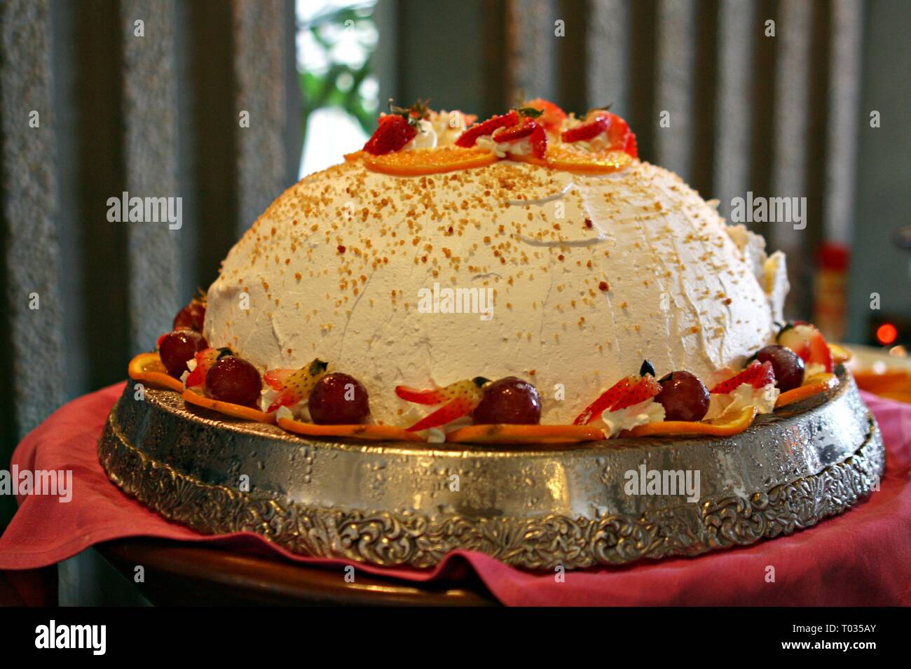 Round ice cream cake topped and bordered with fresh lemon rinds ...