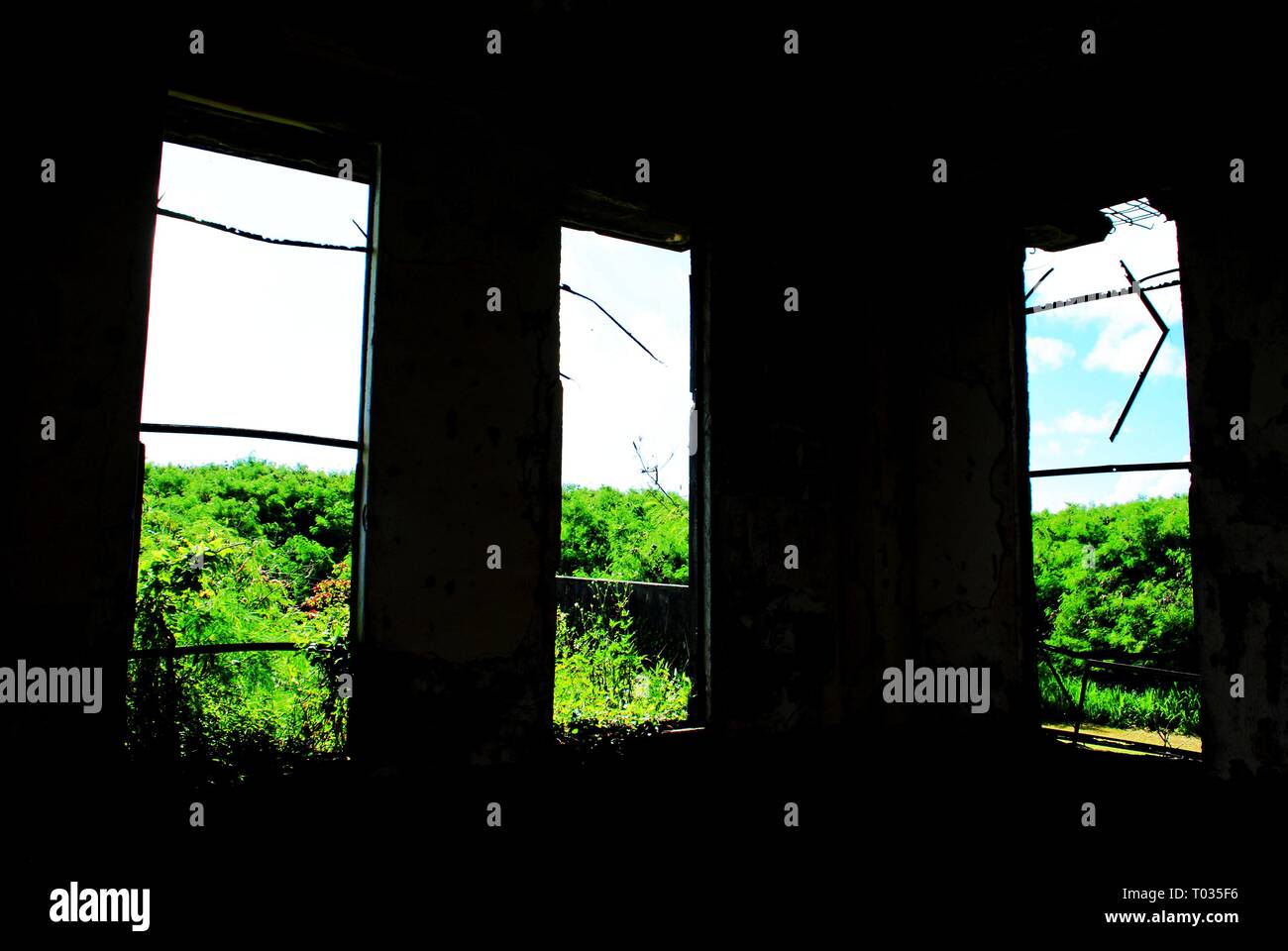 Three windows from an old abandoned ruins of a world war 11 building ...