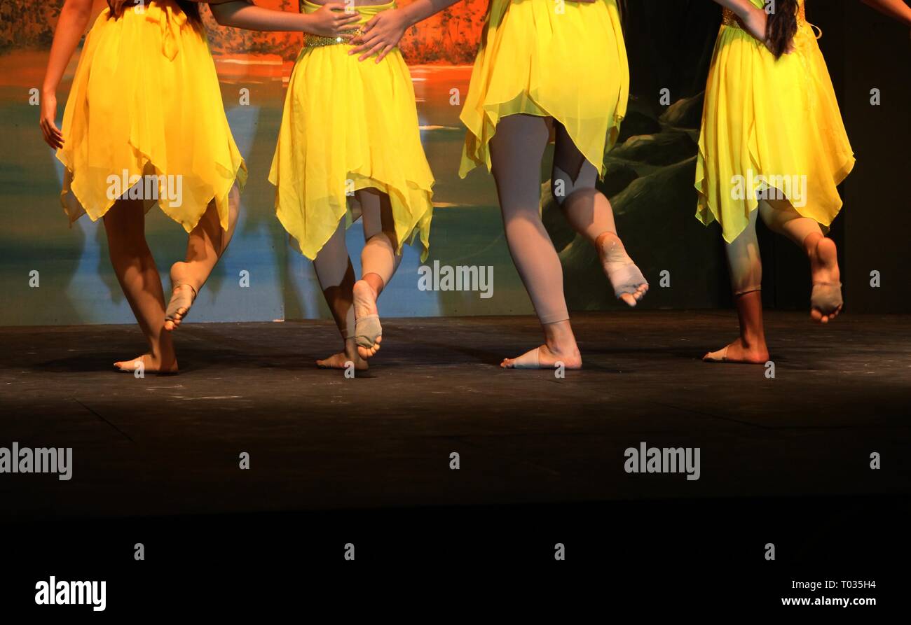 Young ballet dancers in yellow dresses dancing on stage Stock Photo - Alamy